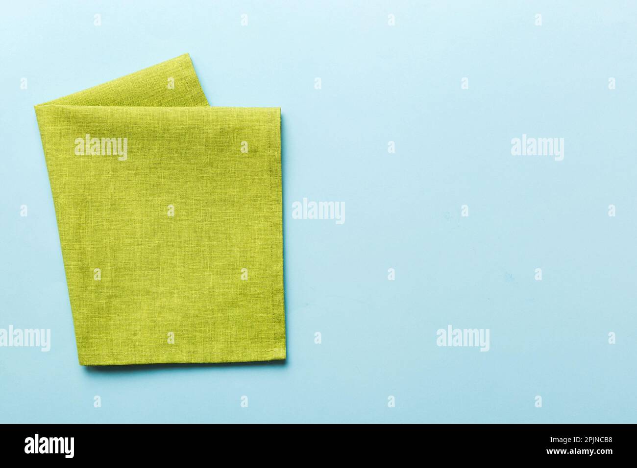 top view with green kitchen napkin isolated on table background. Folded ...