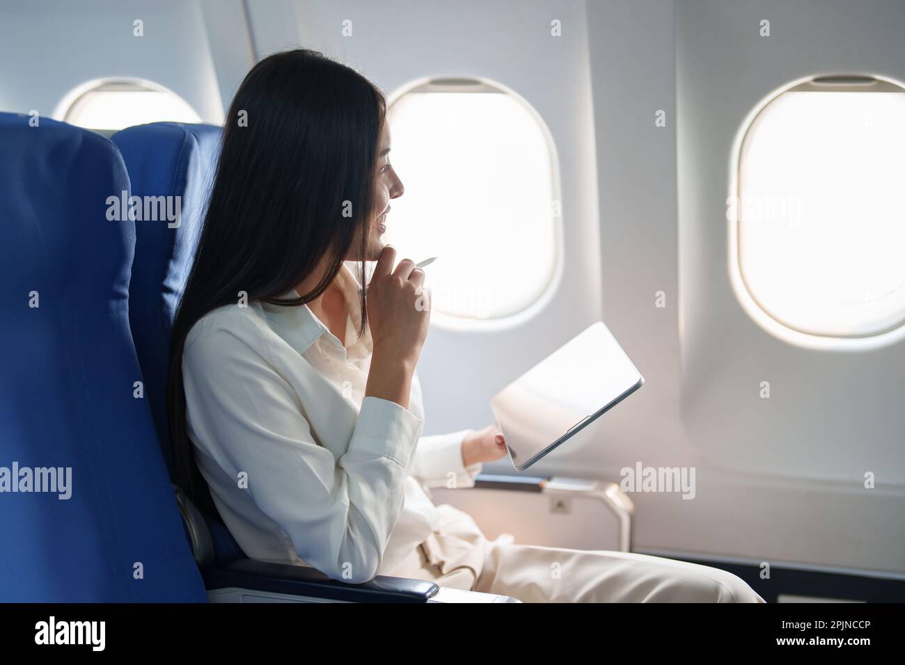 Asian attractive business woman passenger sitting on business class ...