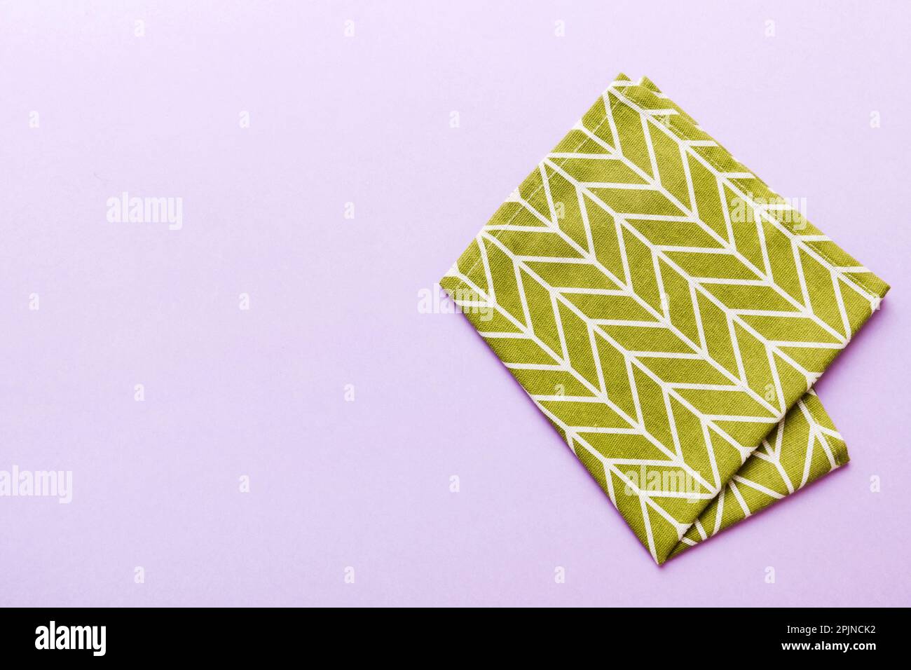 top view with green kitchen napkin isolated on table background. Folded ...