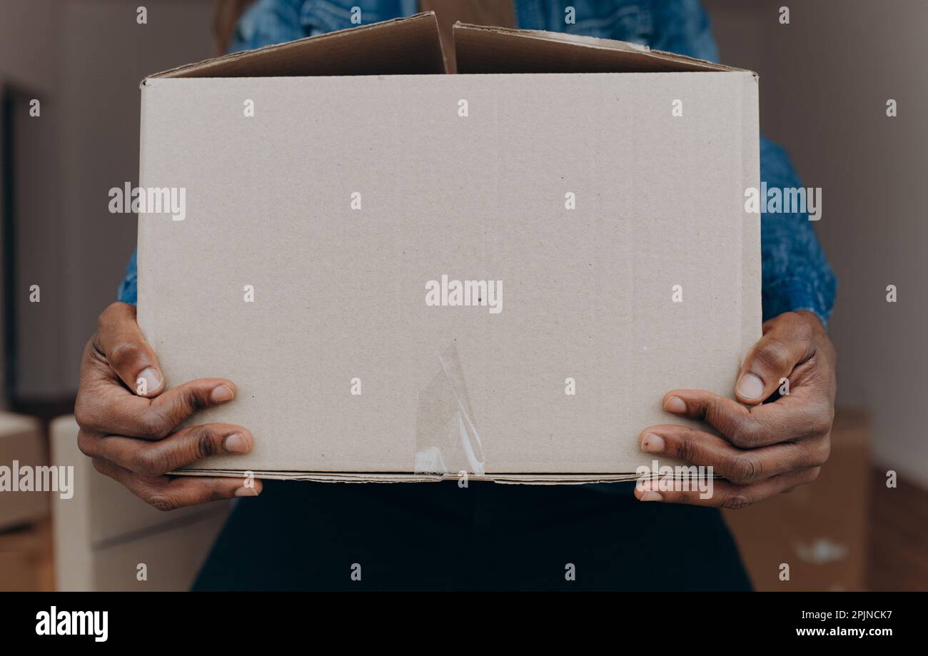 The man lifts a cardboard box Stock Photo - Alamy