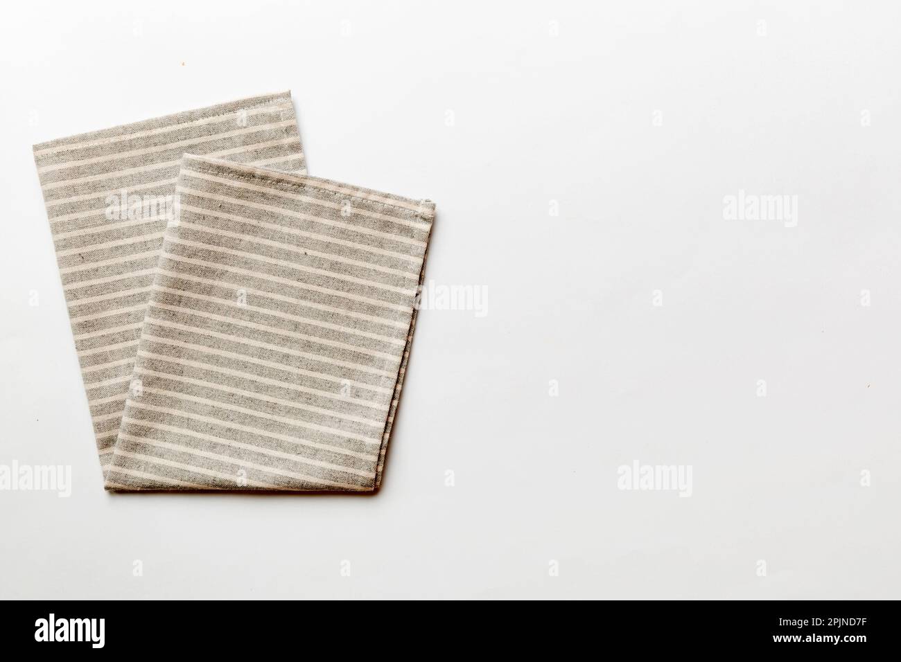 top view with gray kitchen napkin isolated on table background. Folded ...