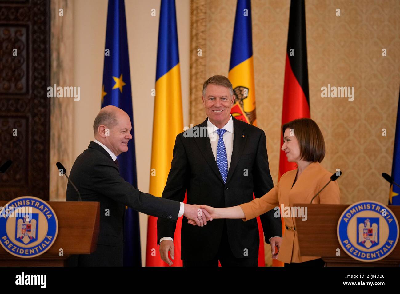 German Chancellor Olaf Scholz, left, shakes hands with Moldova's ...