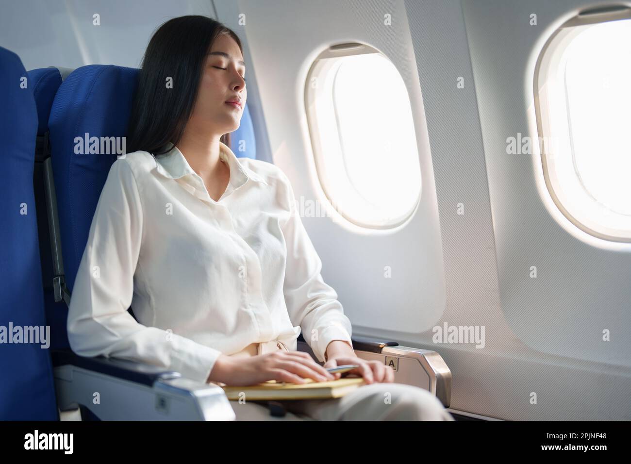 Asian attractive business woman passenger sitting on business class ...