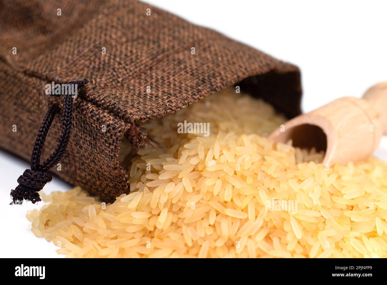 Rice grains in jute sack against white background Stock Photo - Alamy