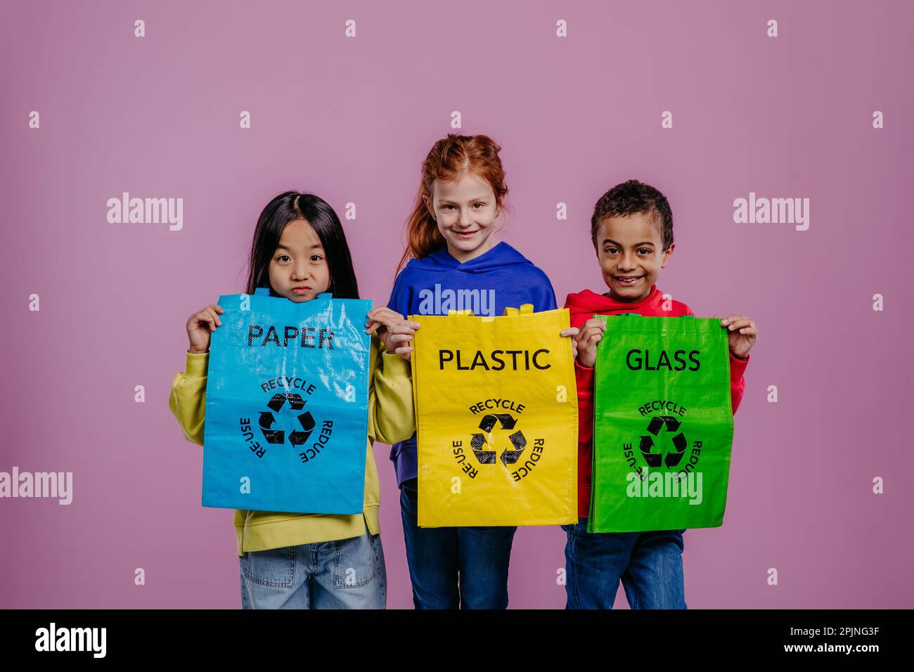 Portrait of three children posing with bins for separated waste Stock ...