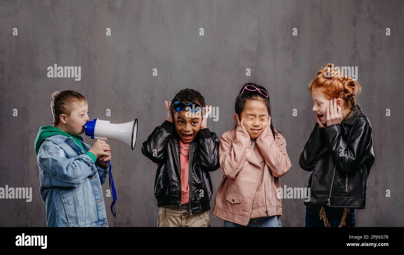 Studio shoot of child with megaphone shouting at other children Stock ...