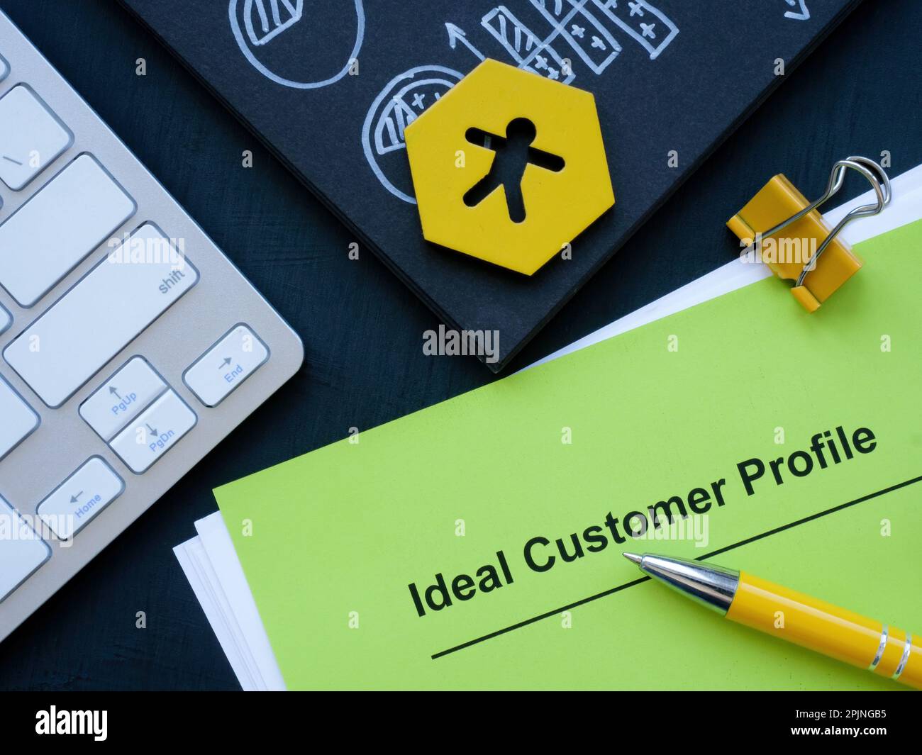 Stack of papers with Ideal customer profile and keyboard Stock Photo ...