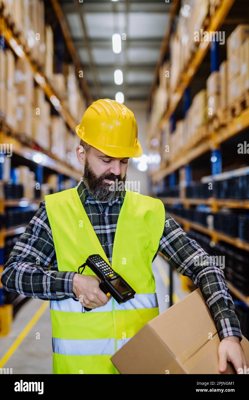 Warehouse worker stocking goods in a warehouse Stock Photo - Alamy