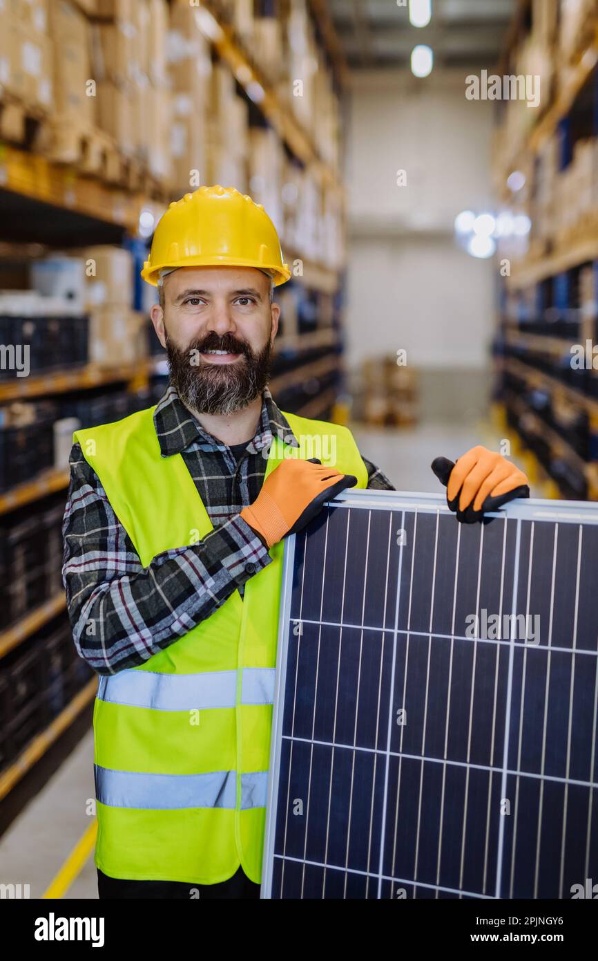 Portrait of warehouse worker with solar panel Stock Photo - Alamy