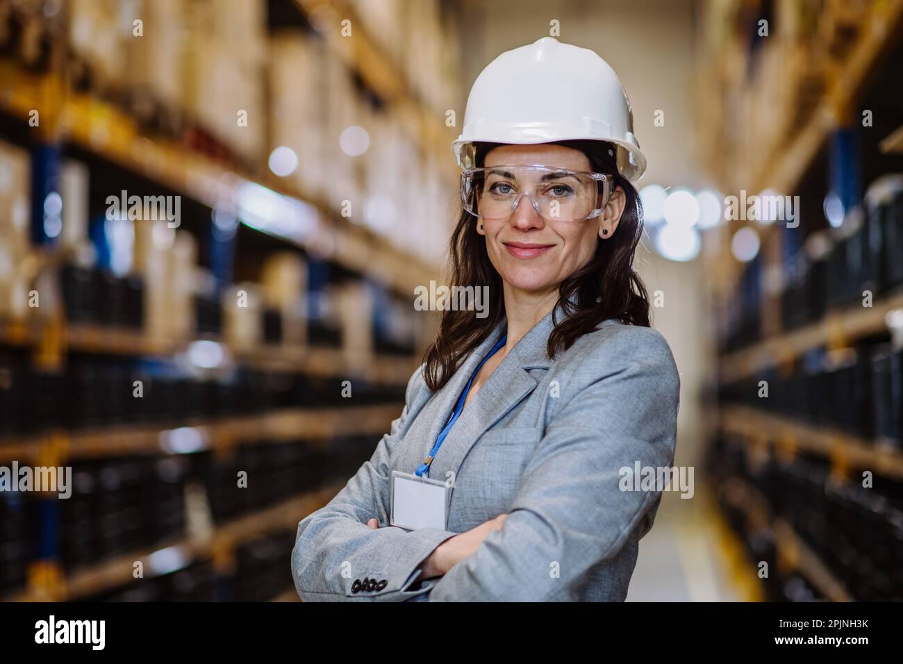 Manager woman in suit controlling goods in a waehouse Stock Photo - Alamy
