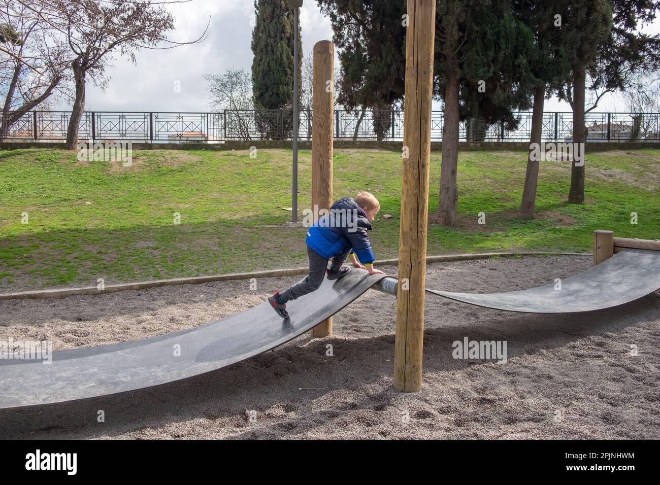Cute little boy playing in a rubber bridge at the playground Stock ...