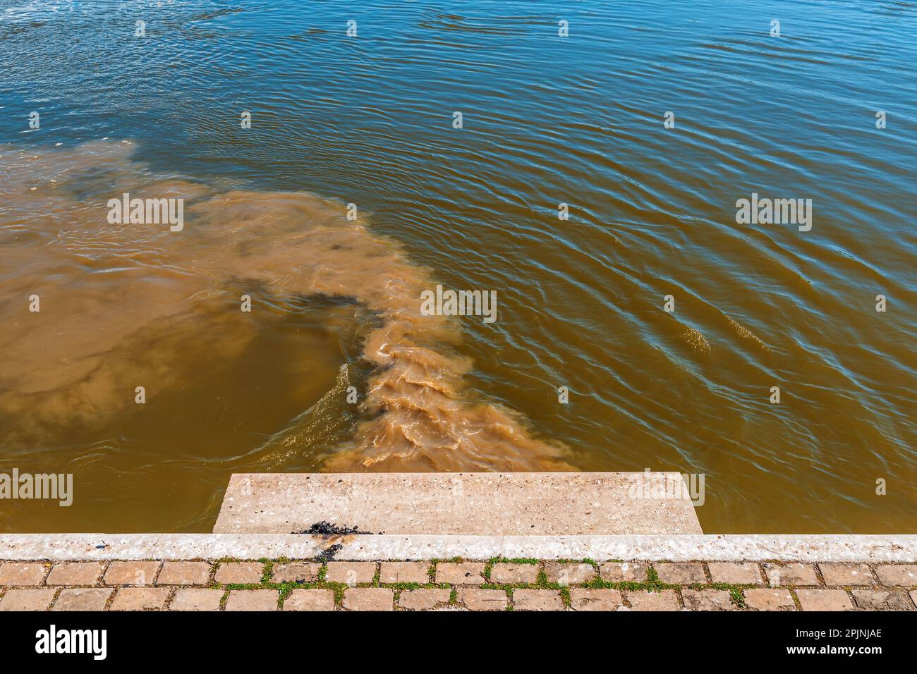 Sewage pipe outfall into the river, water pollution and environmental ...