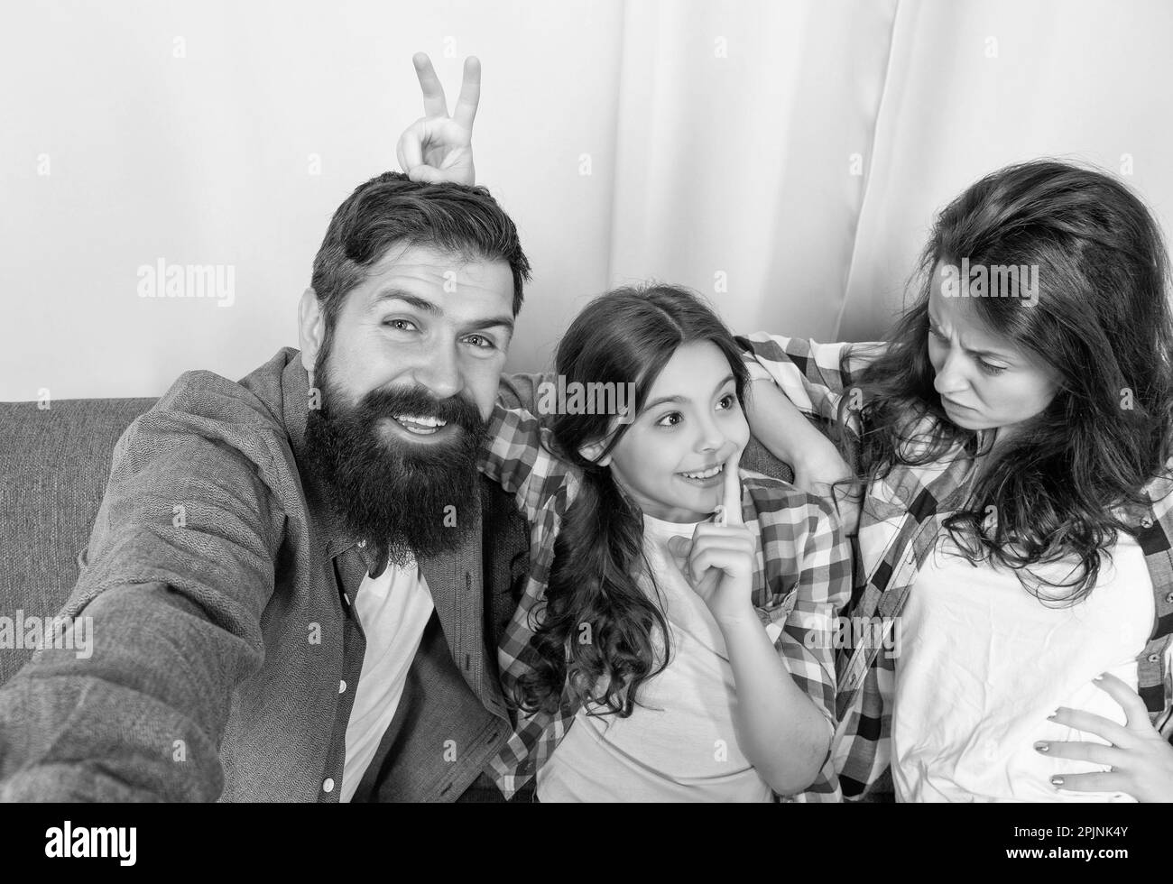 friendly family having fun. funny parents with kid girl at home. mom ...