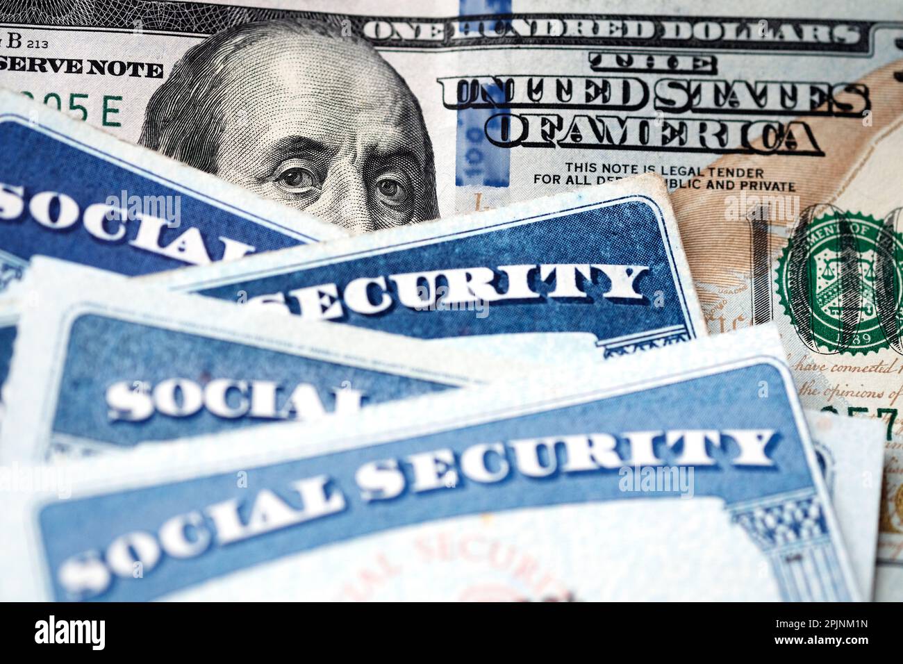 Several Social Security Cards on a US United States one hundred dollar ...