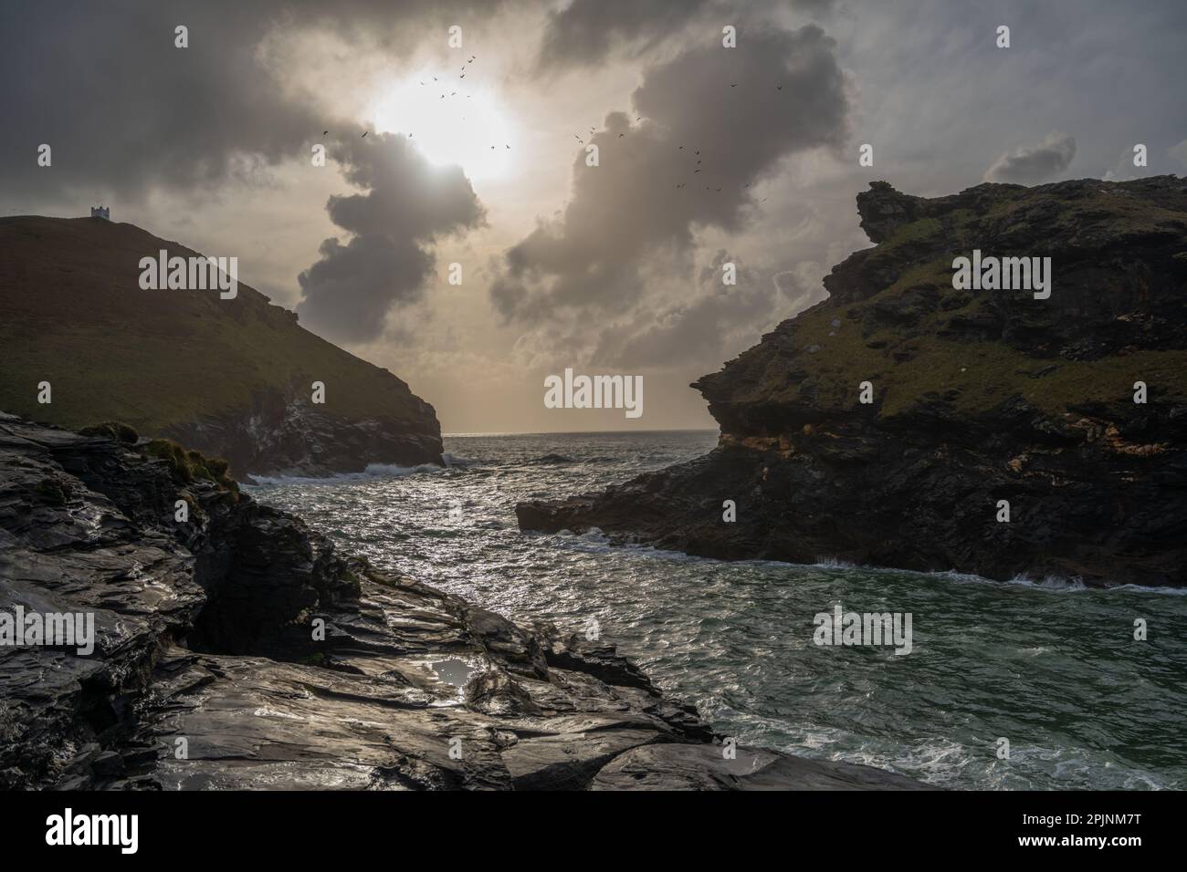 Storm clouds and a high tide at the entrance to Boscastle Harbour ...