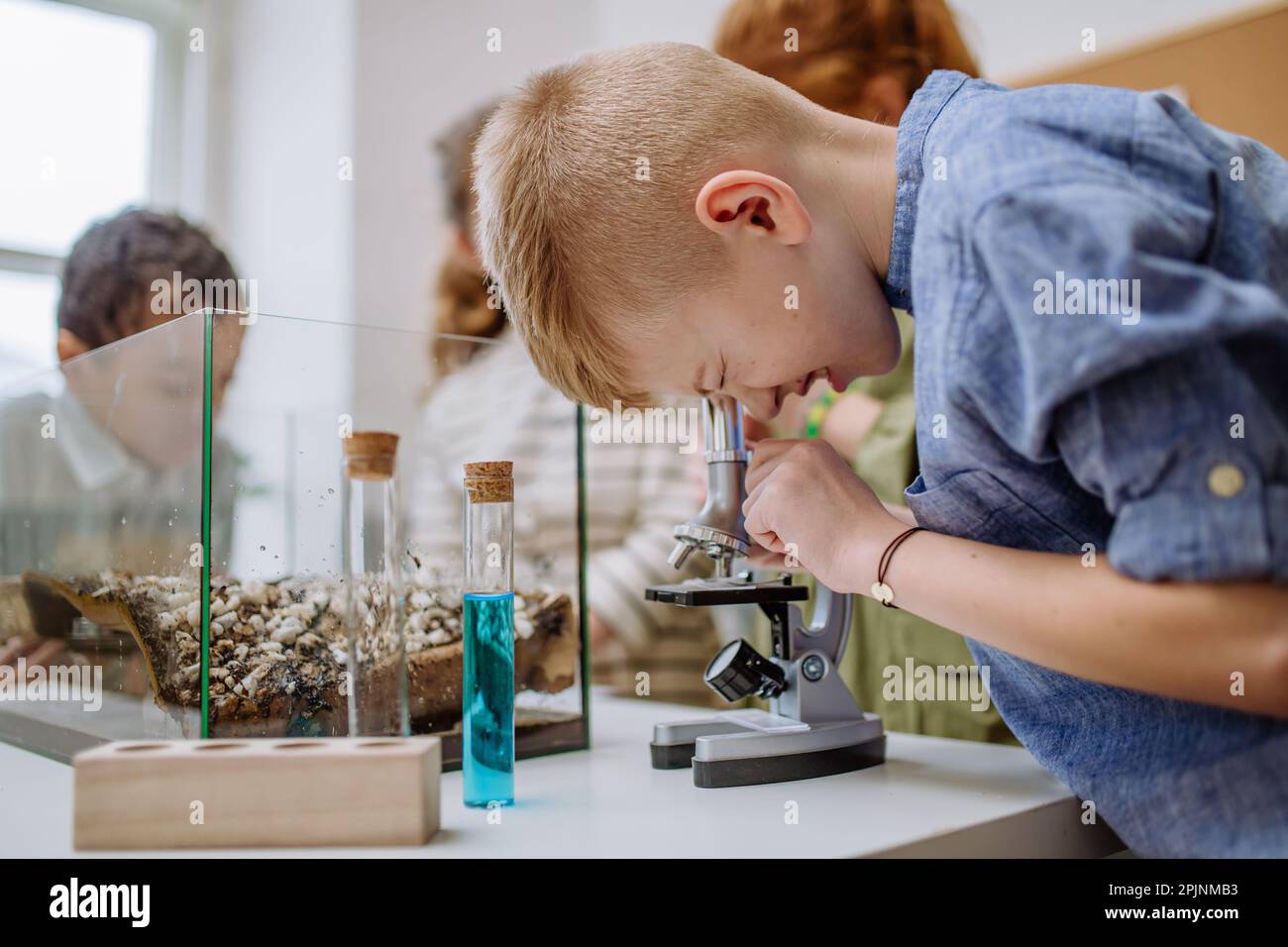 Little boy looking in microscope during science lesson Stock Photo - Alamy