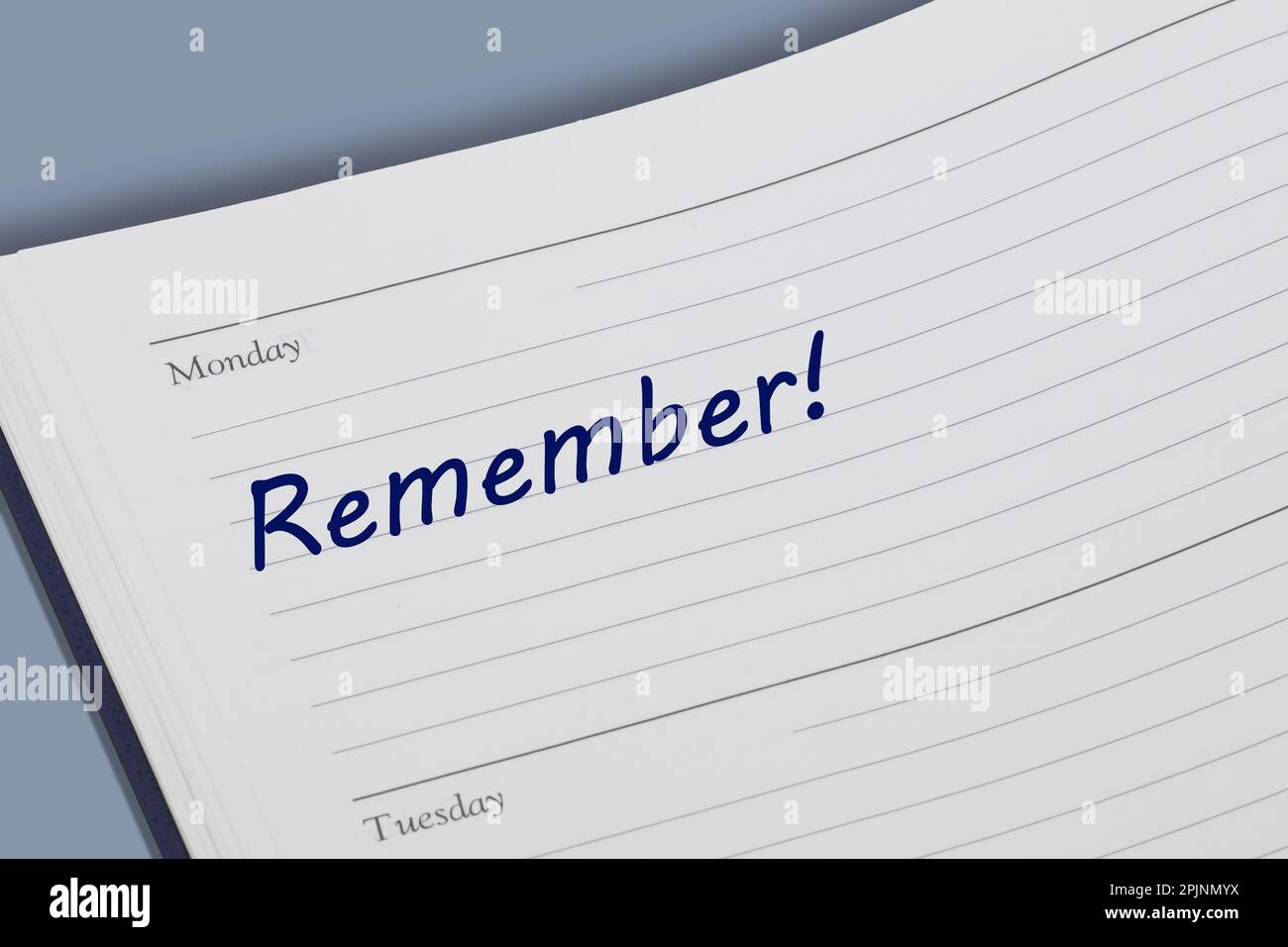 Remember blue ink reminder note in a diary page Stock Photo - Alamy