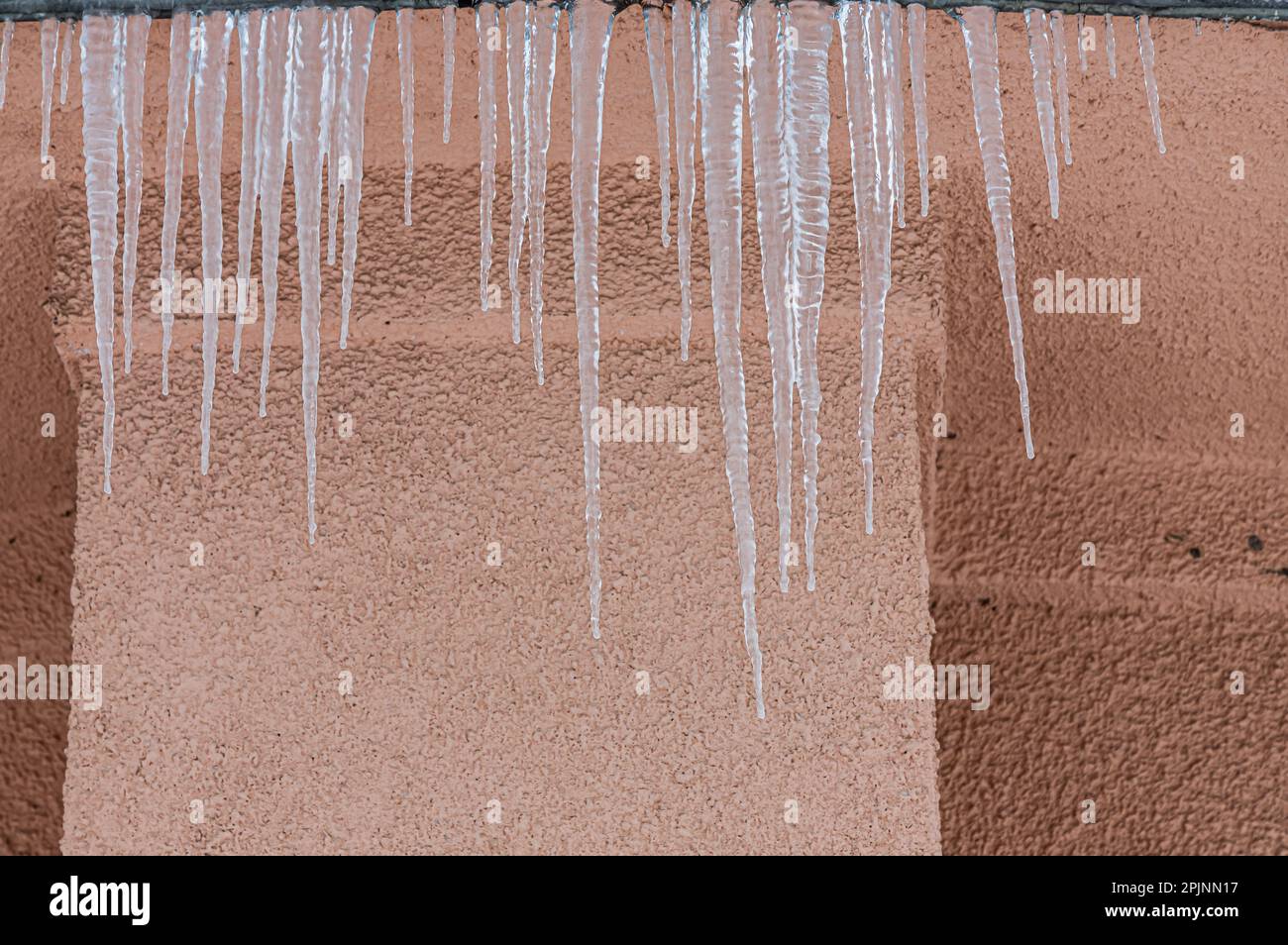 Icicles on the roof. The drain is full of snow and ice. Icicles falling ...