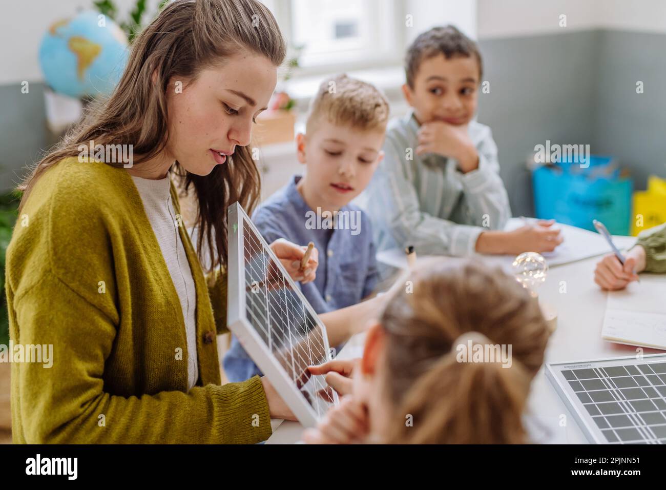 Young teacher with solar panel learning pupils about solar energy Stock ...