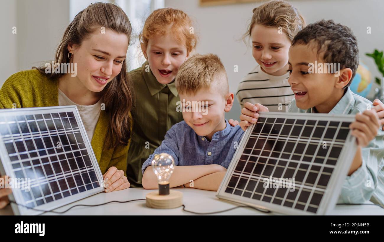 Young teacher with solar panel learning pupils about solar energy Stock ...