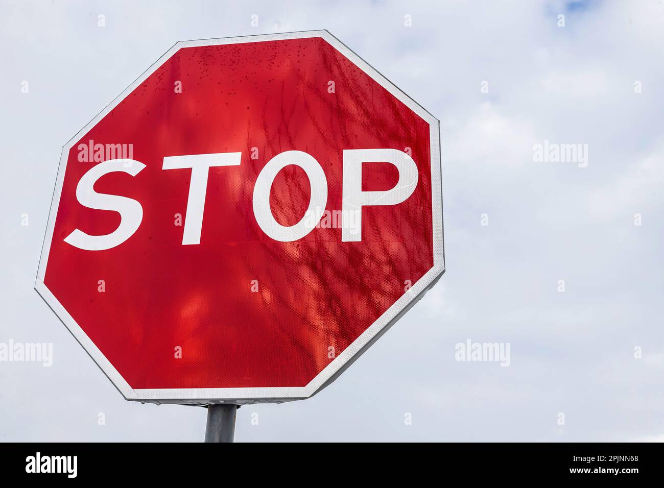 roadside red stop sign on a cloudy background. Sign isolated Stock ...