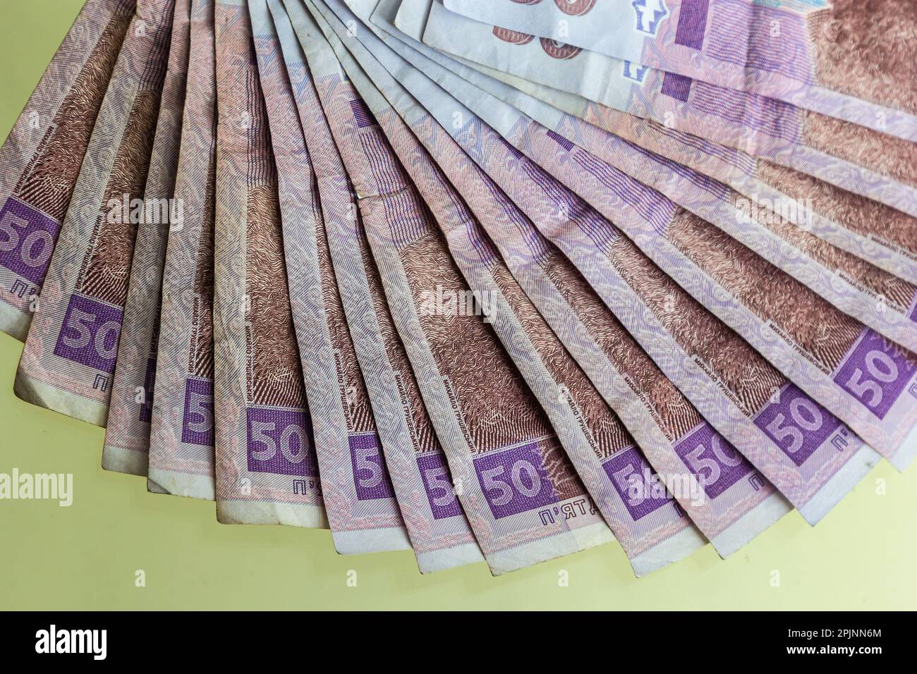 Ukrainian paper money is laid out on a blue background. 50 hryvnia ...