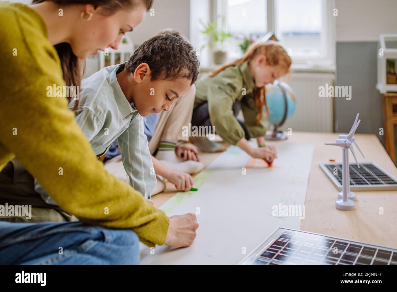 Children drawing a project to environmental lesson Stock Photo - Alamy