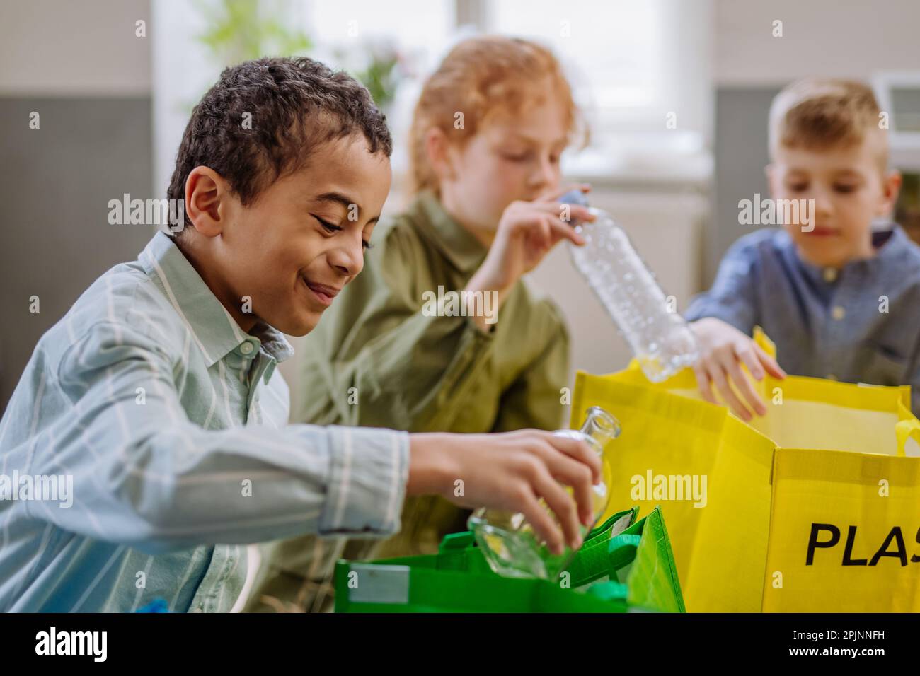 Children separating rubish in to three bins Stock Photo - Alamy