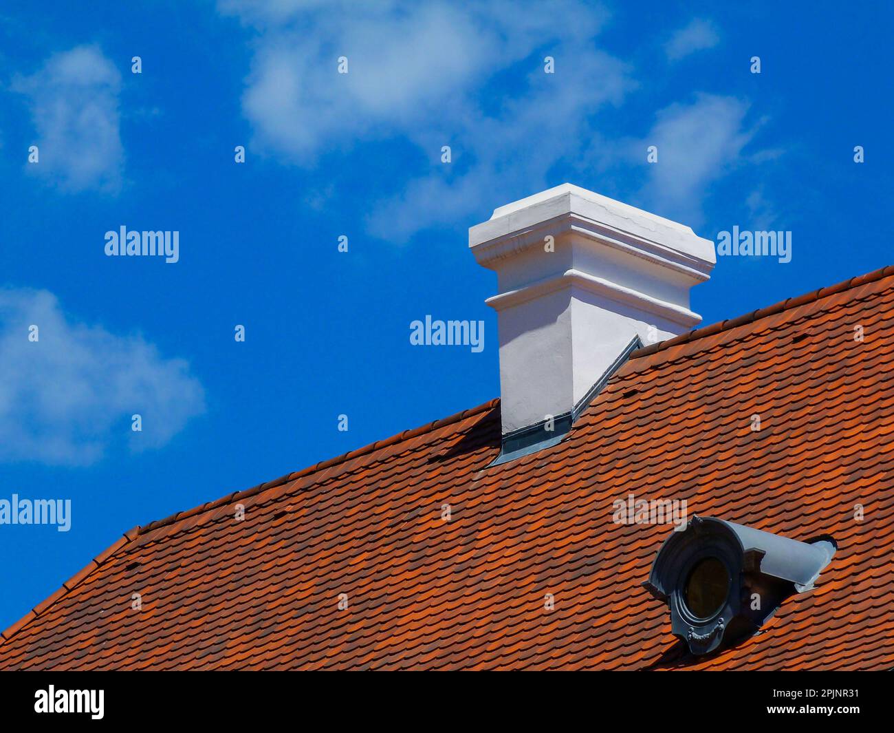 white stucco finished chimney. sloped roof with red brown clay roof ...