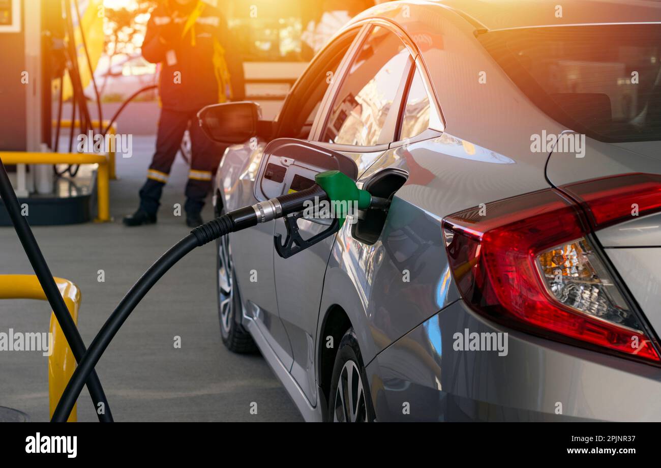 Refuel cars at the fuel pump. The driver hands, refuel and pump the car ...