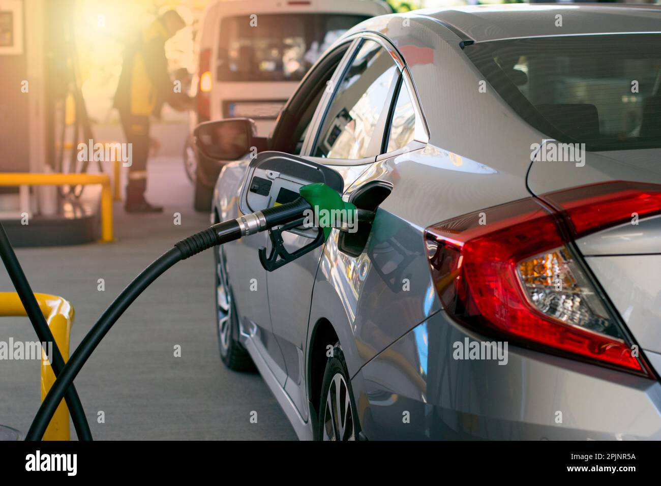 Refuel cars at the fuel pump. The driver hands, refuel and pump the car ...