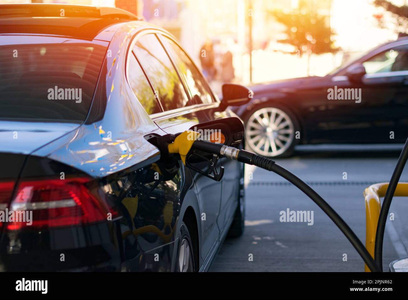 Refuel cars at the fuel pump. The driver hands, refuel and pump the car ...