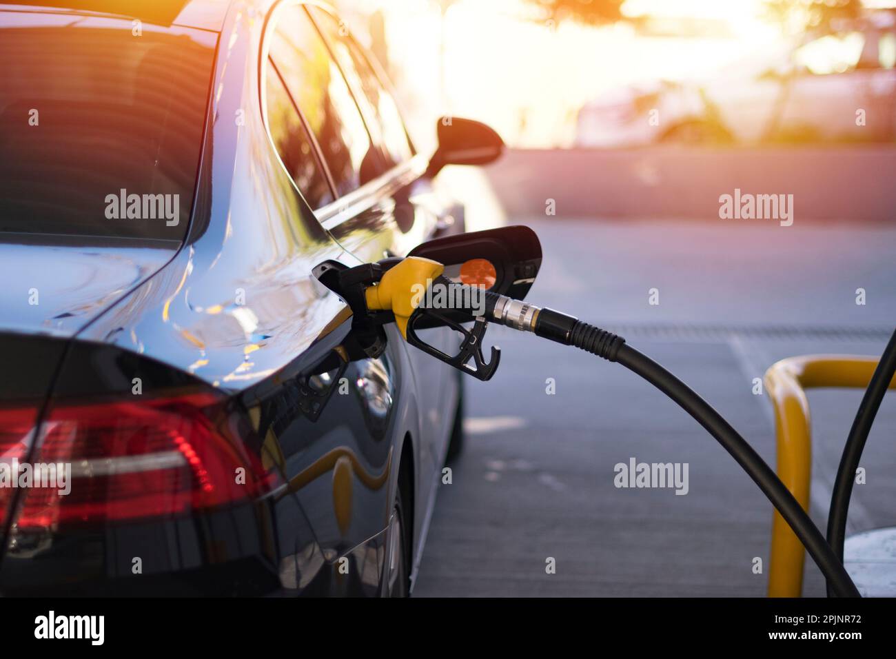 Refuel cars at the fuel pump. The driver hands, refuel and pump the car ...