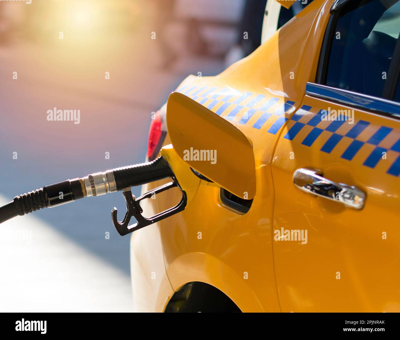 Taxi at gas station being filled with fuel on Turkey. The driver hands ...