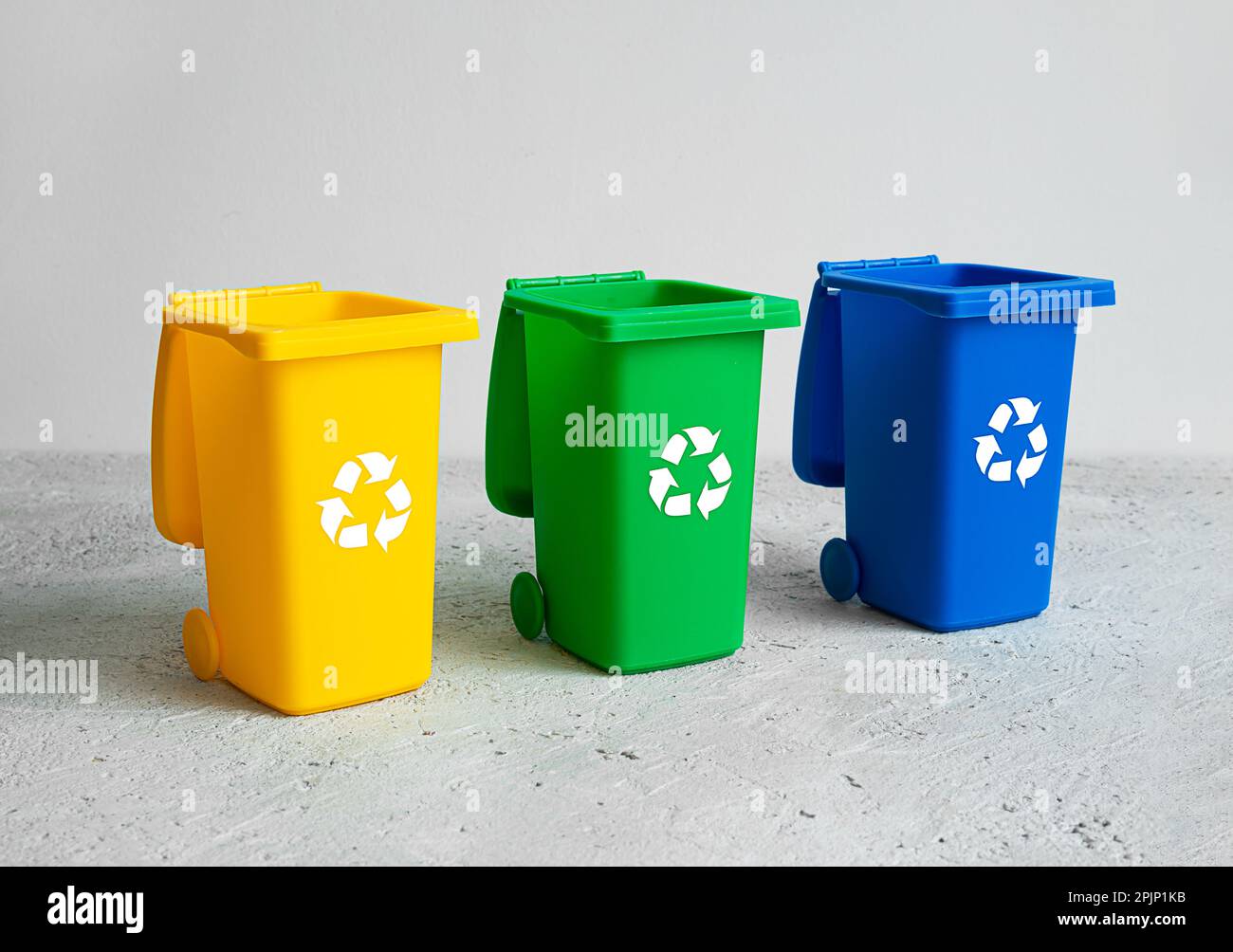 Blue, yellow and green open tank for separate garbage collection on a ...