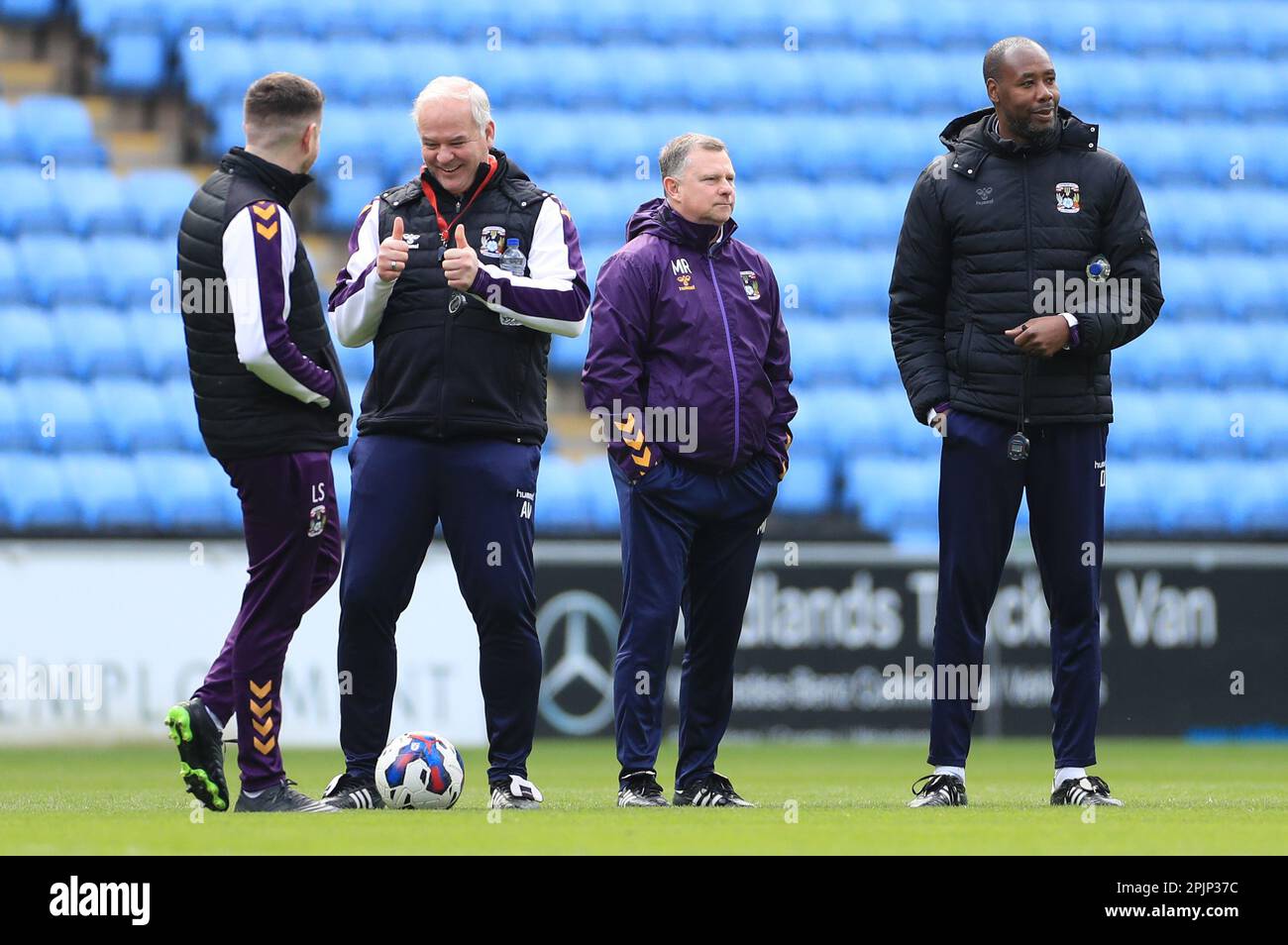 Coventry City manager Mark Robins (second right), assistant manager Adi ...