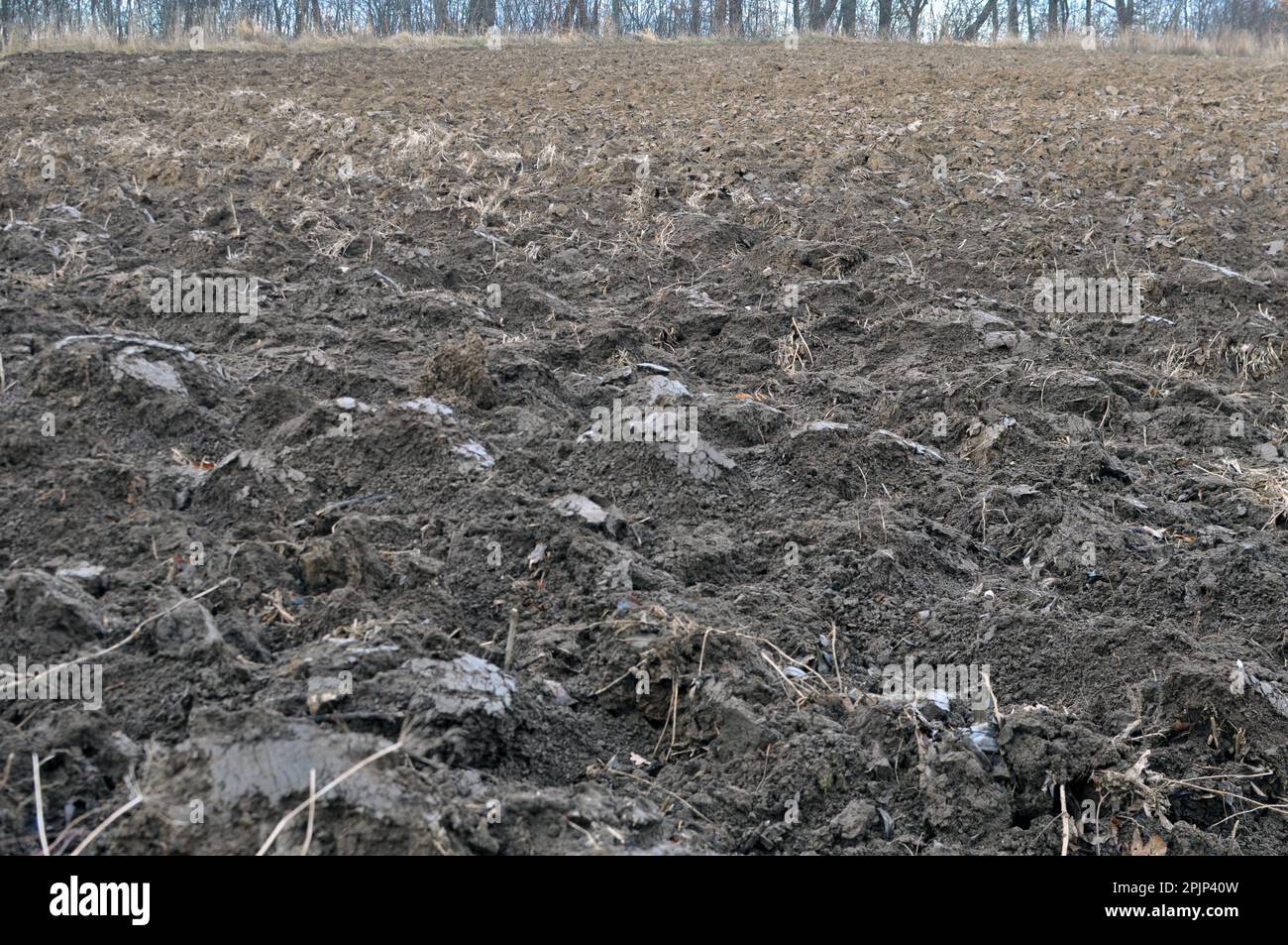 Plowing plow in autumn field with boulders of the earth Stock Photo - Alamy