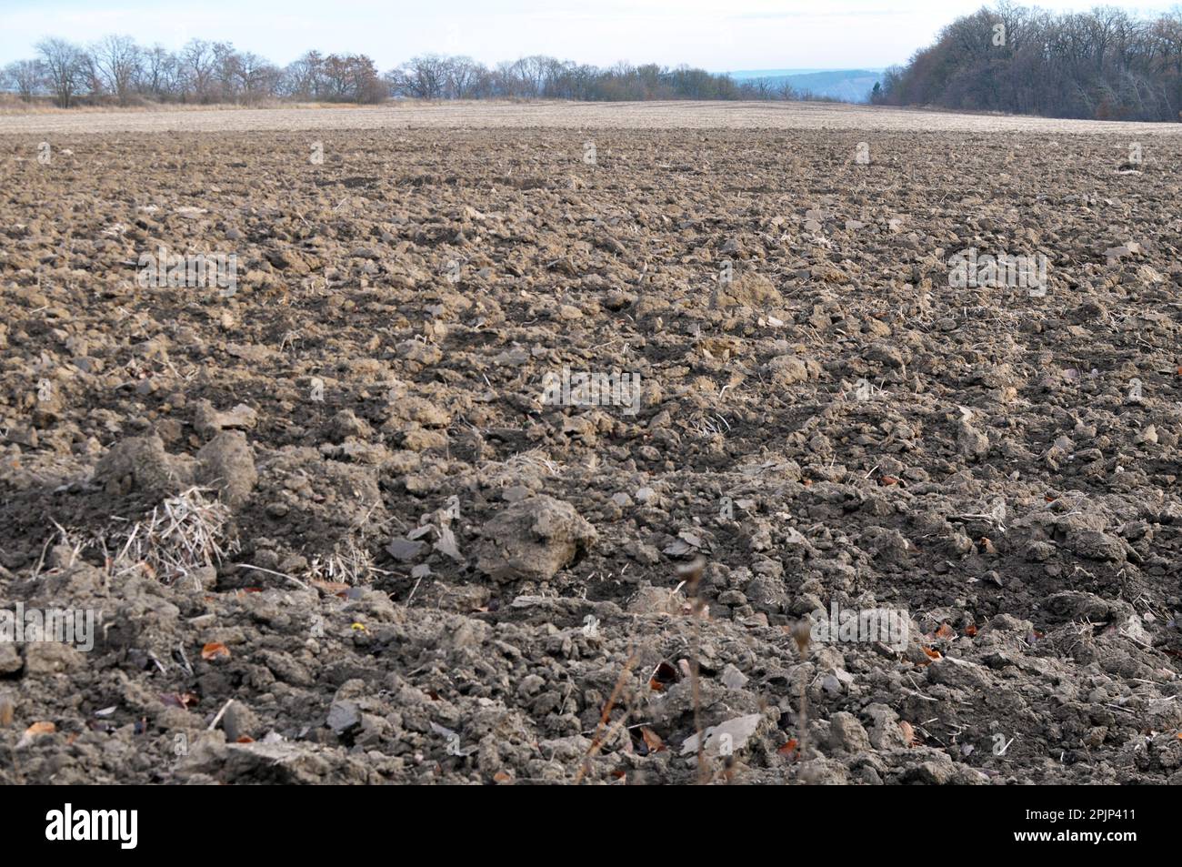Plowing plow in autumn field with boulders of the earth Stock Photo - Alamy