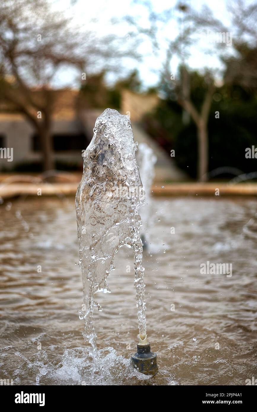 A jet of water from a fountain on an out-of-focus background.Fast ...
