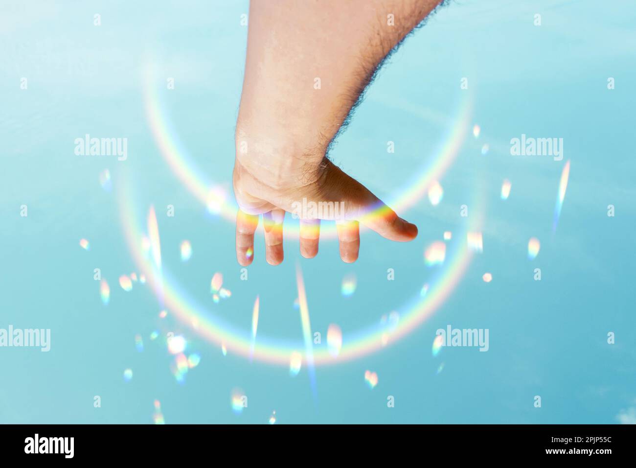 hand raised in the blue sky gesturing with the sunlight Stock Photo - Alamy