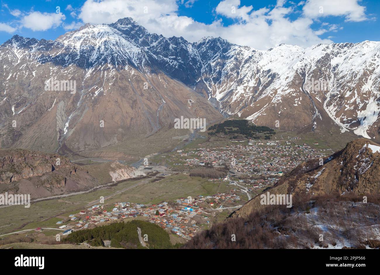 Aerial view of Stepantsminda townlet, Georgian mountain landscape on a ...