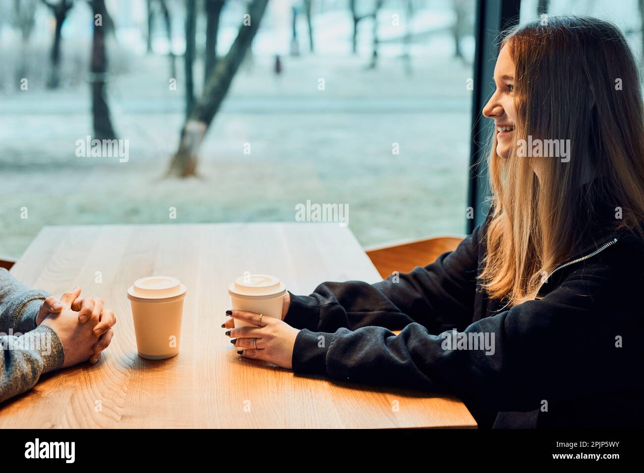 Friends having a chat, talking together, drinking coffee, sitting in a ...