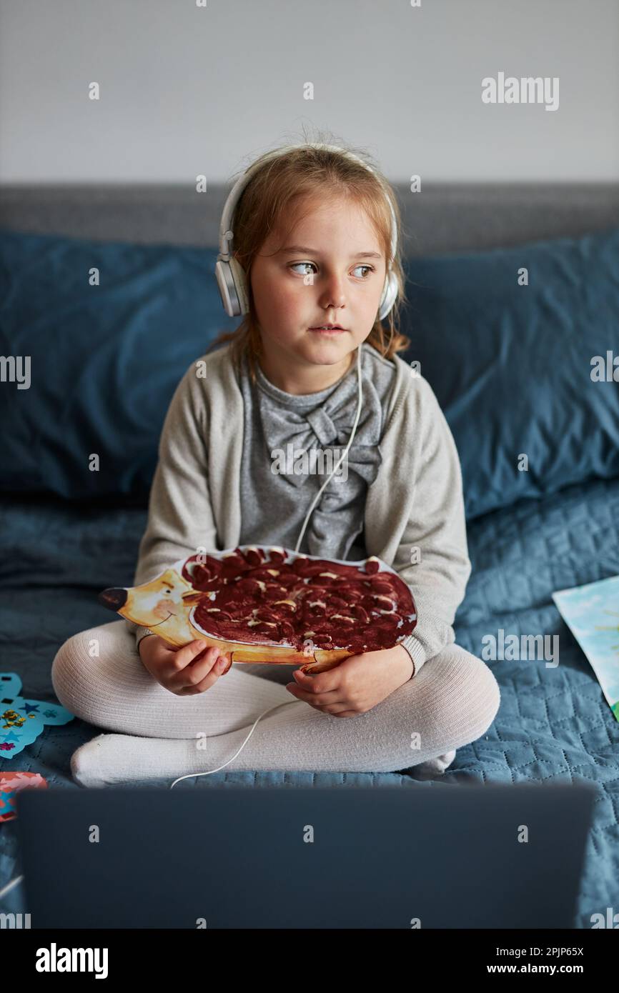 Little girl preschooler learning online showing her works drawings done ...