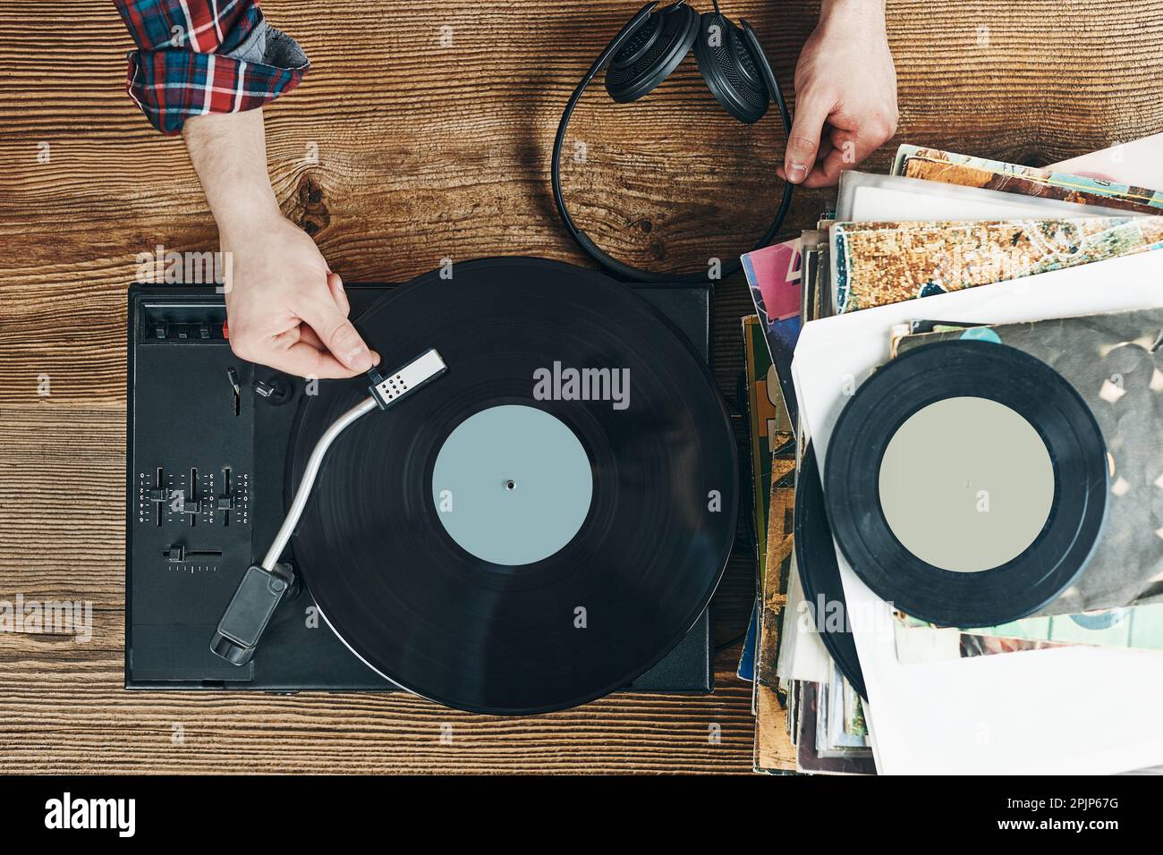 Man listening to music from vinyl record. Playing music from analog ...