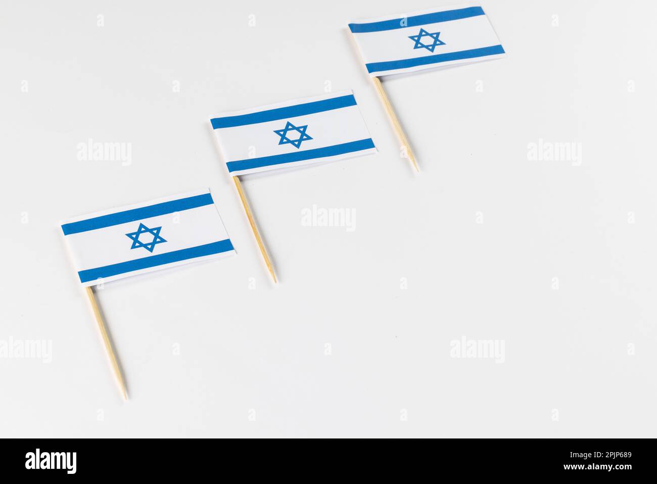 Close up of three flags of israel with copy space on white background ...