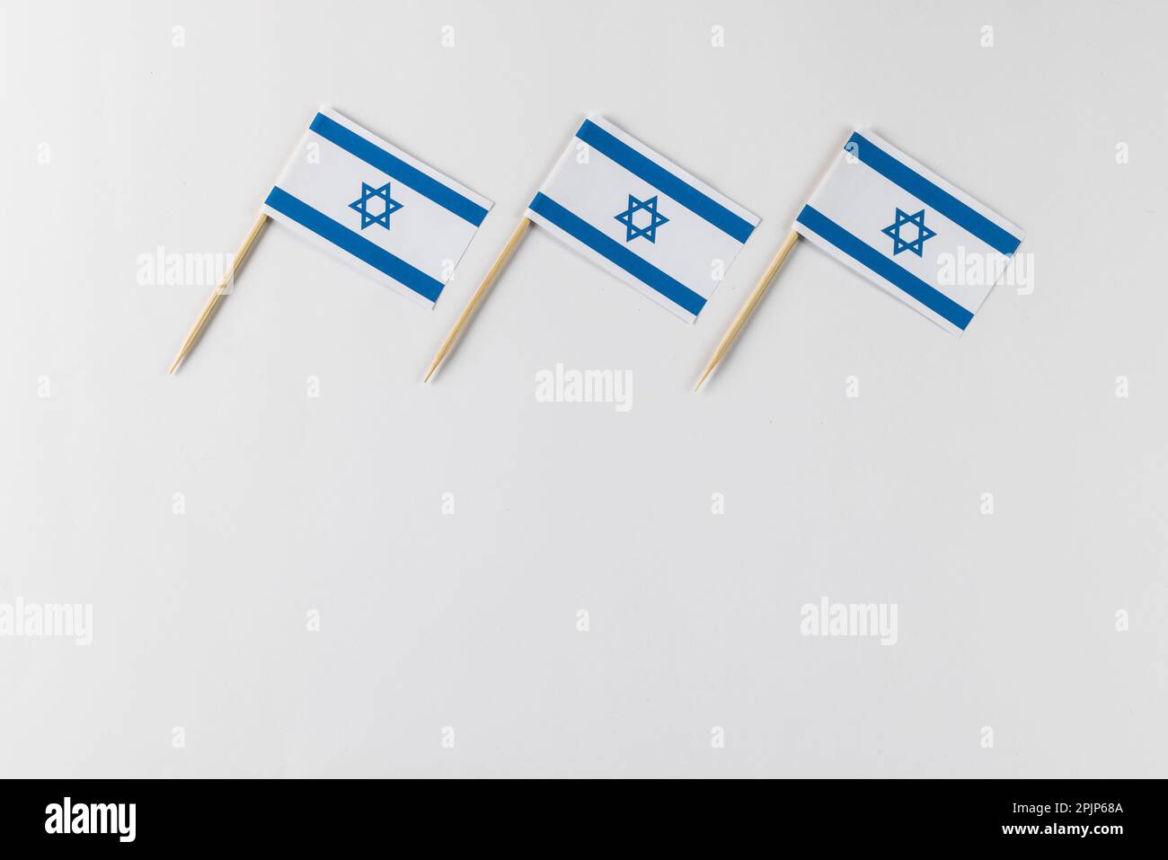 Close up of three flags of israel with copy space on white background ...