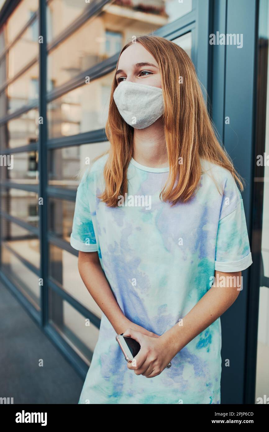 Portrait of young woman girl standing at store front downtown holding ...
