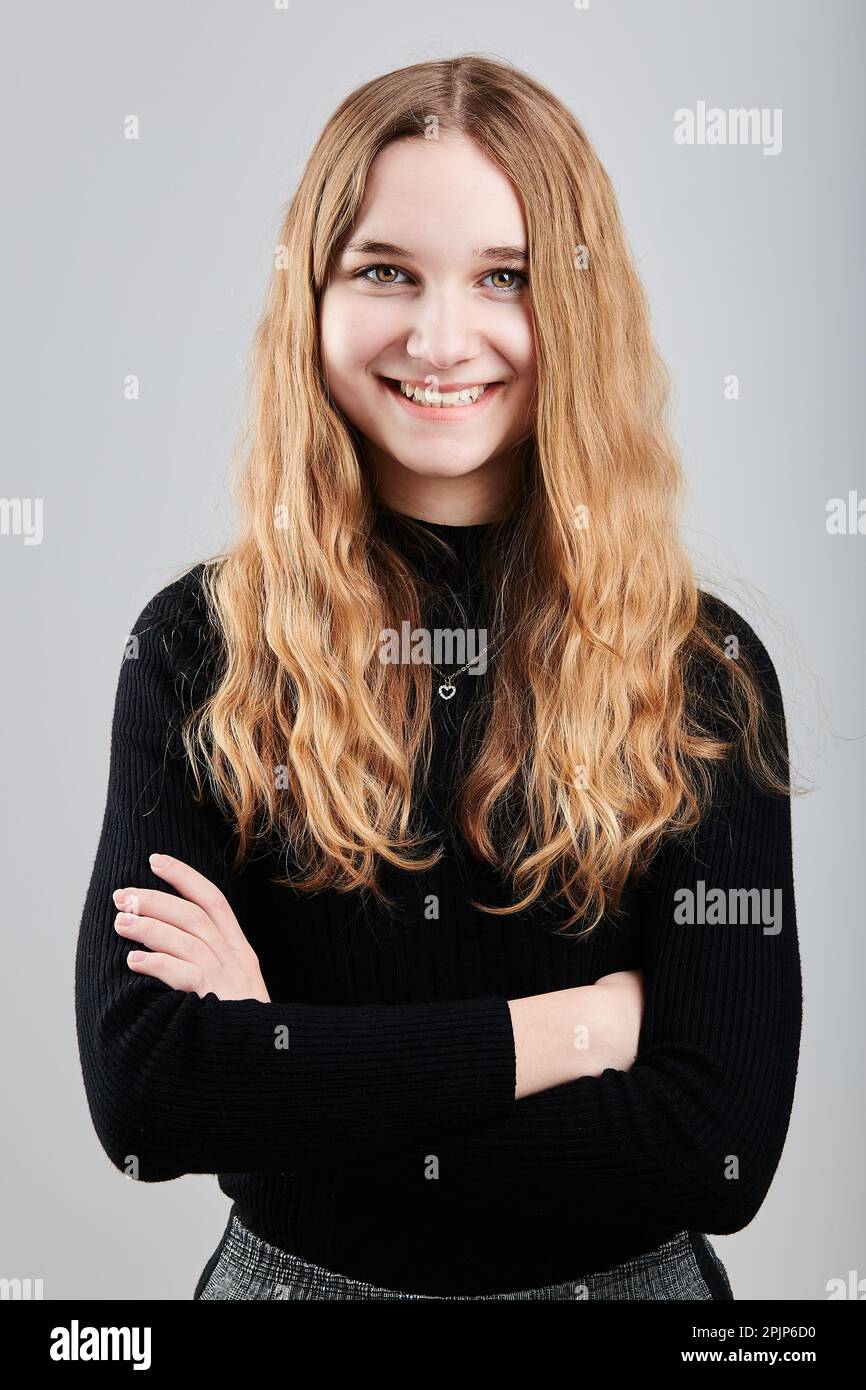Portrait of pretty cheerful young woman holding arms crossed standing ...