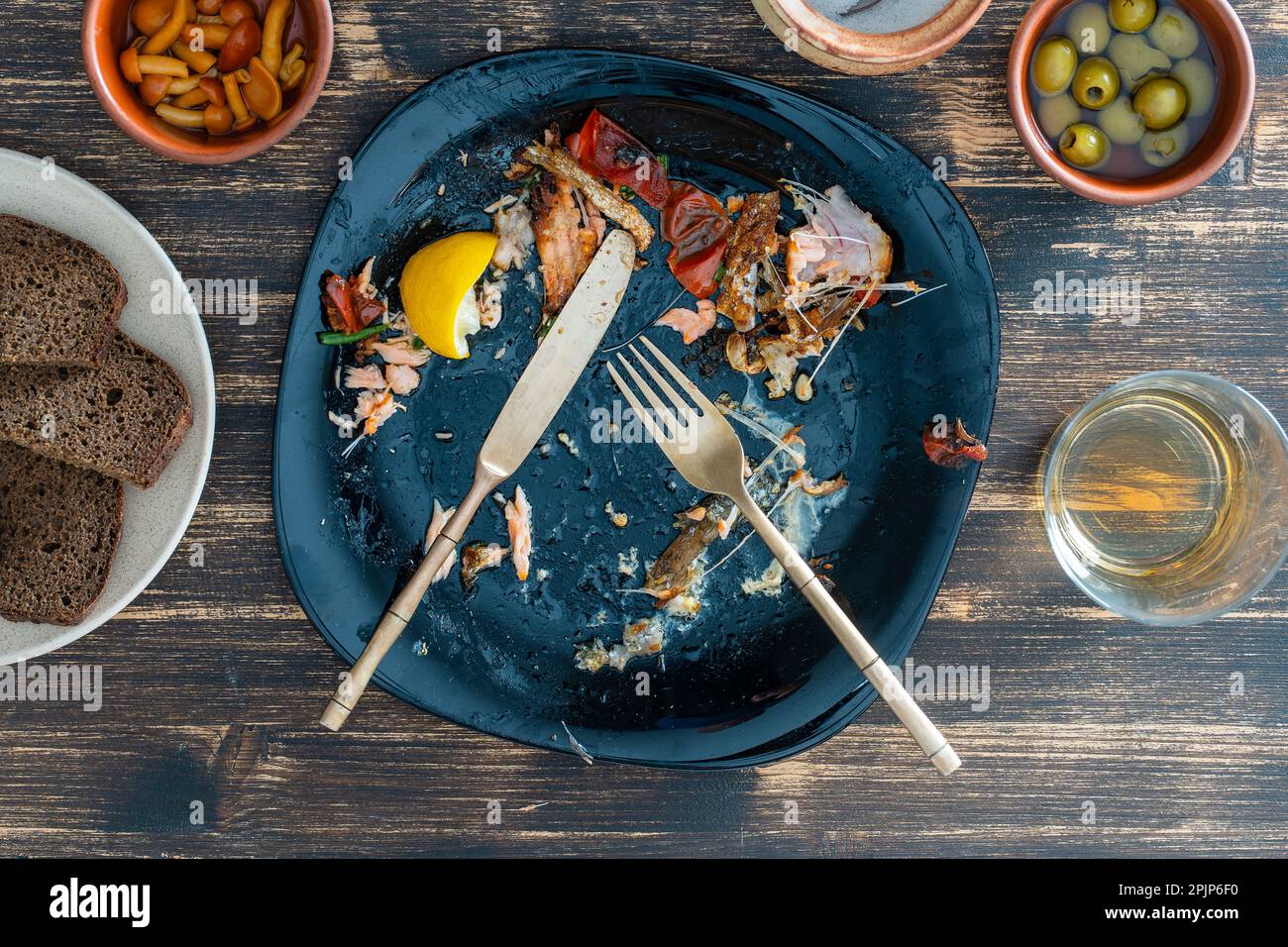 Top view of empty black plate, dirty after the meal is finished. Dirty ...