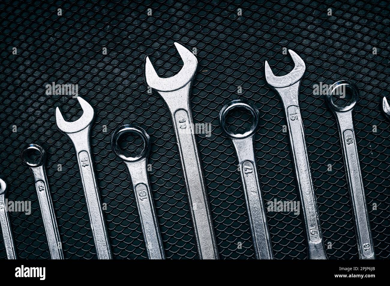 Set of chrome wrenches on steel surface. Mechanic tools for maintenance ...